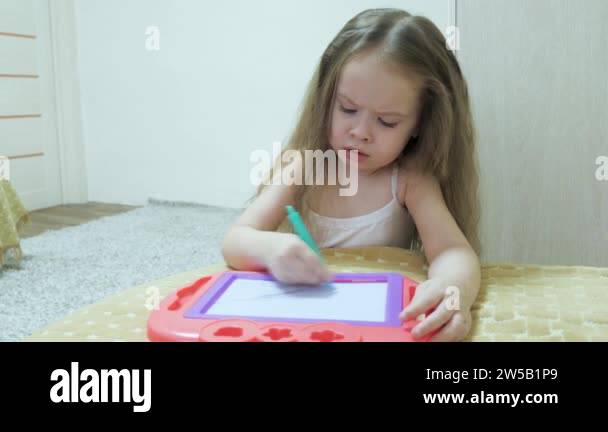 Cute little kid girl artist playing alone drawing coloring picture with ...