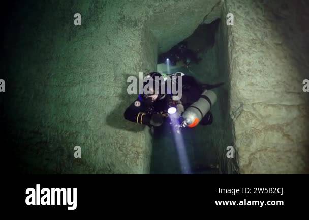 Technical diver in red flippers in the underwater cave of Budapest ...