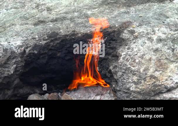 Flame of Methane Underground Emerges From Crack Between Rocks and Burns ...
