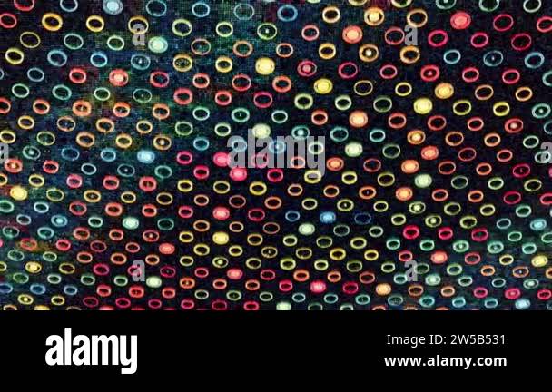 Moving surface with many small round shaped silhouettes and colorful ...