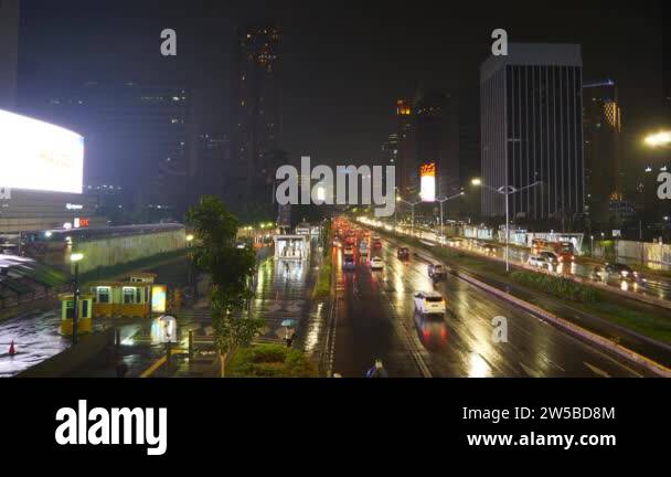 Night illumination in Jakarta city. Night traffic on street. Indonesia ...