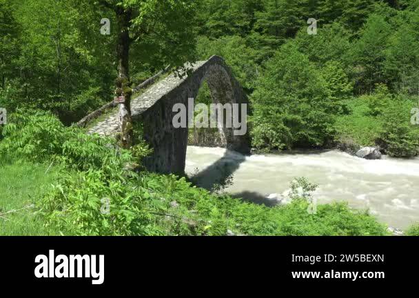 An arch bridge is a bridge with abutments at each end shaped as a ...