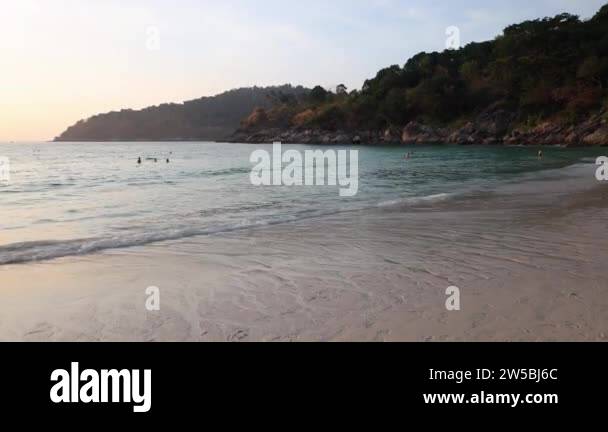 Tropical Freedom beach in Phuket where people walk and swim. Two girls ...