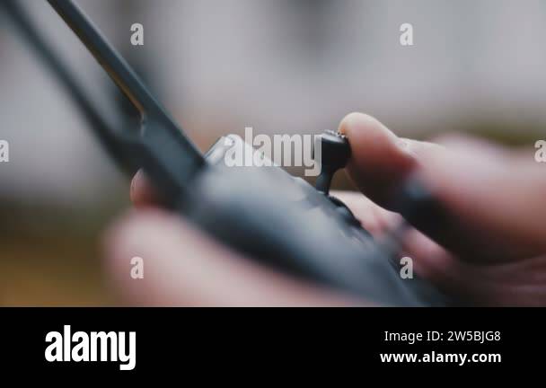Ultra close-up, male hand finger pushing on remote control joystick ...