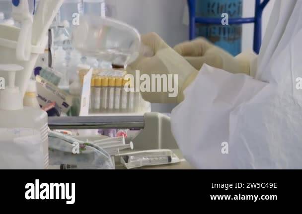 He Dials The Medicine Into The Syringe. A Bottle Of Saline Solution For ...