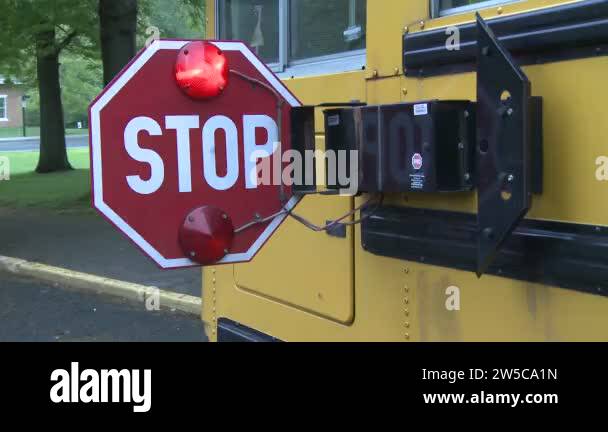 Bus stop sign with hazard lights on. (3 of 5 Stock Video Footage - Alamy