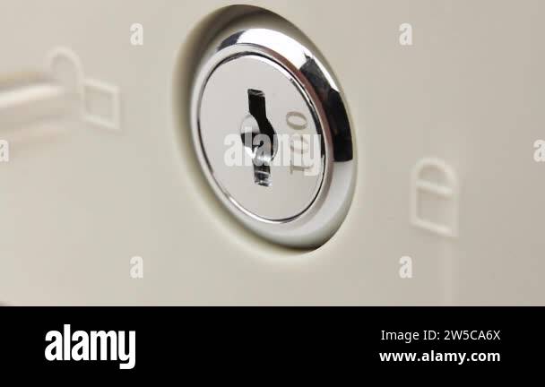 human try to open lock of safe or cash drawer with key, gets stuck and ...