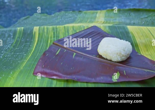 Mango sticky rice served on a spotted banana leaf by the pool.speckled ...