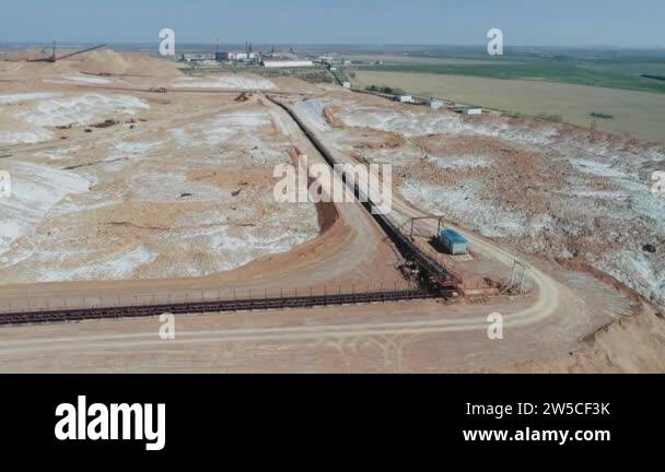 Salt piles, aerial view of industrial quarries, conveyor in salt pits ...
