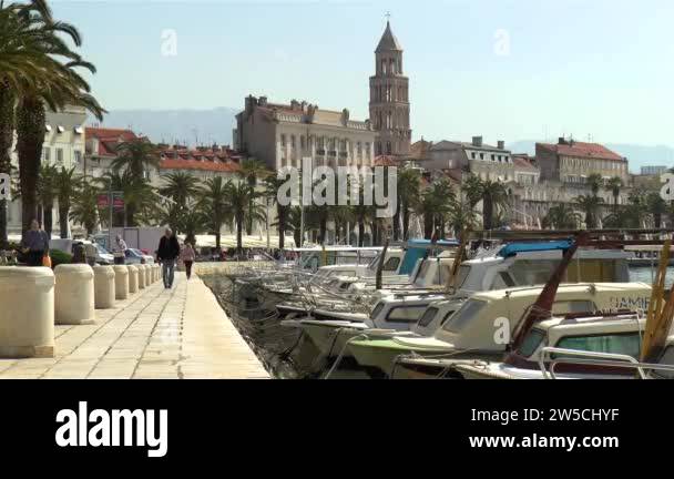 People, boats and palm trees in the City of Split, Croatia. People ...