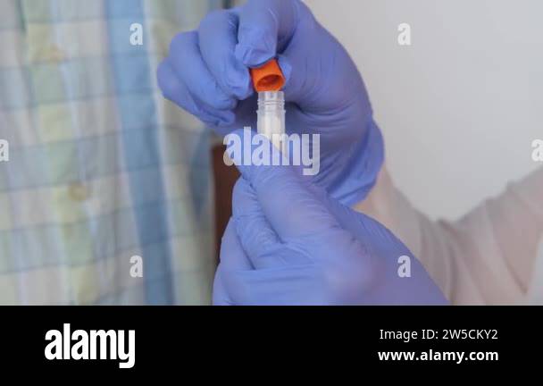 girl holds a kit for a dna test in a box, a cotton swab for scraping ...