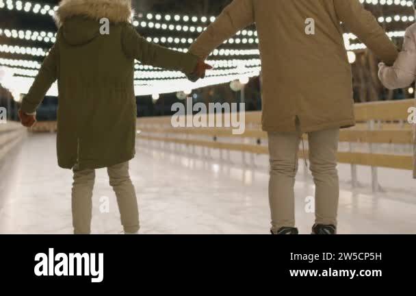 Full back-view footage of multi-generational family in winter clothing ...