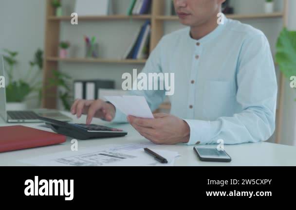 business man use phone to scan barcode or QR codes to pay credit card bill after receiving ...