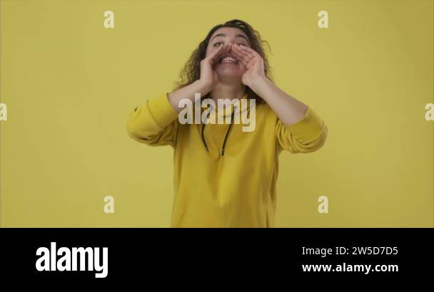 Woman shouting with hands cupped around mouth Stock Video Footage - Alamy
