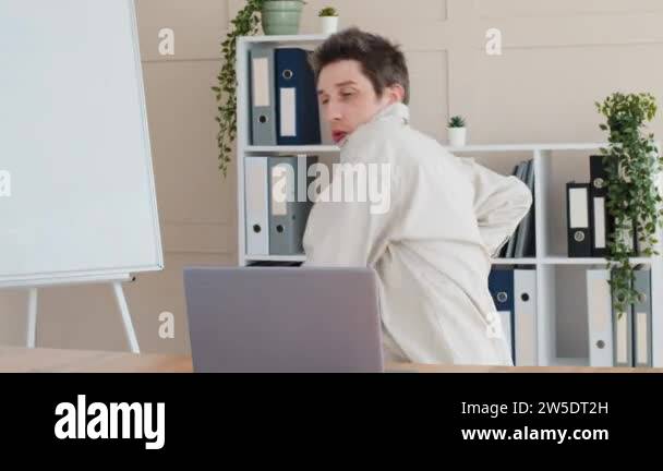 Funny caucasian man male millennial freelancer sitting down at desk in ...