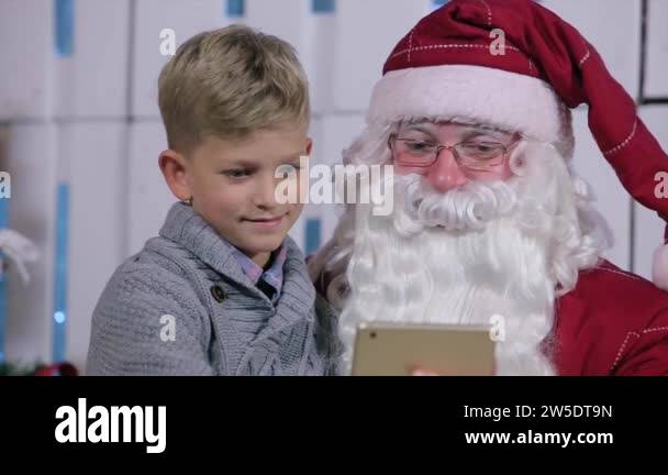 Little Boy Sits in Santas Lap, Flipping Through pages on Tablet Stock ...