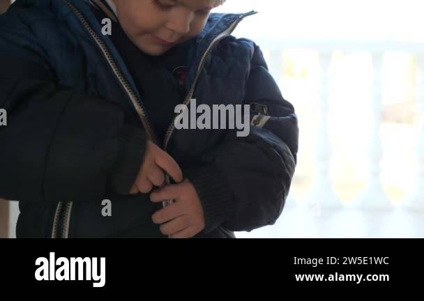 Cute Child Zipping his own Jacket. Little Boy Wearing Winter Attire. 2x ...
