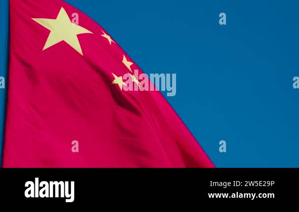 Chinese Flag Wiggles the Wind. The Big State Flag is illuminated by the ...