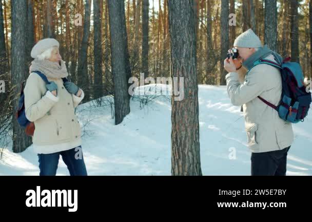 Senior wife posing for camera and having fun while husband taking ...