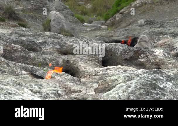 Flame of Methane Underground Emerges From Crack Between Rocks and Burns ...