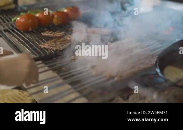 Traditional Turkish cuisine cooked in Adana Kebab grill. Chef cooking ...