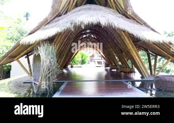 fly through a bamboo shed with a reed roof in Ubud, Bali. Aerial view ...