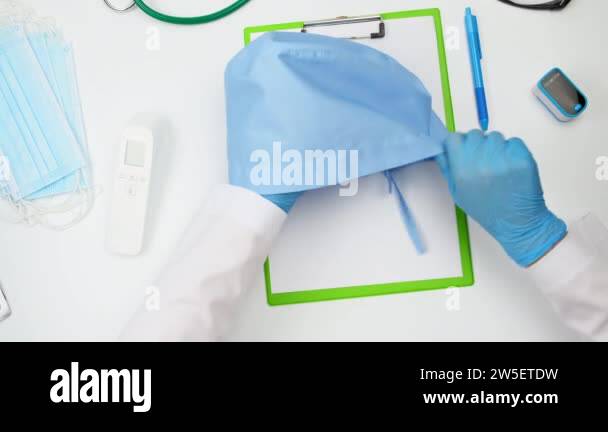 two hand hold blue textile medical cap with ties for doctor, top view ...