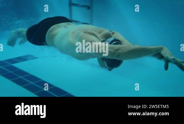 Adaptive amputee athlete swimming underwater in indoor pool Stock Video ...