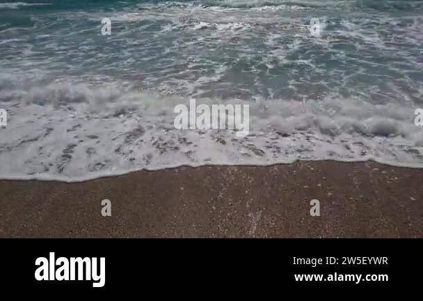 Sea waves splashing against the sea shore, powerful transparent water ...