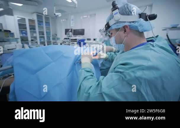 Operating room, patient is under deep anesthesia, surgeon with ...