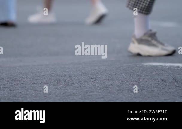 Busy city life crosswalk crowded people street walking feet shoes legs ...