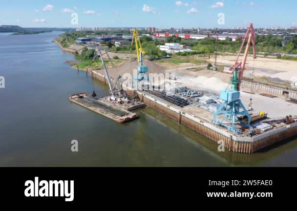 A port crane unloads a barge. River port, dredging works. Aerial photography Stock Video Footage ...