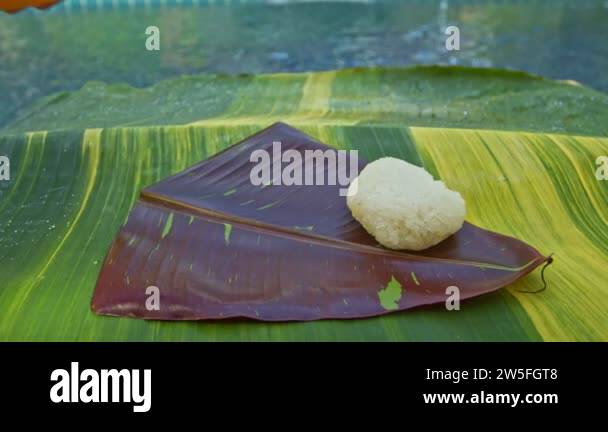 Mango sticky rice served on a spotted banana leaf by the pool.speckled ...
