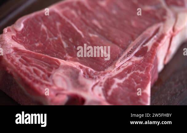 Super close-up of T-bone steak - raw marble beef fillet, aged prime ...