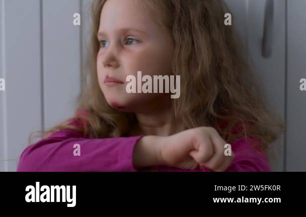 Victim of kids abuse and domestic violence. Close up of scared little ...