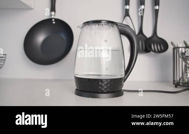 process of heating drinking water in a transparent glass electric ...