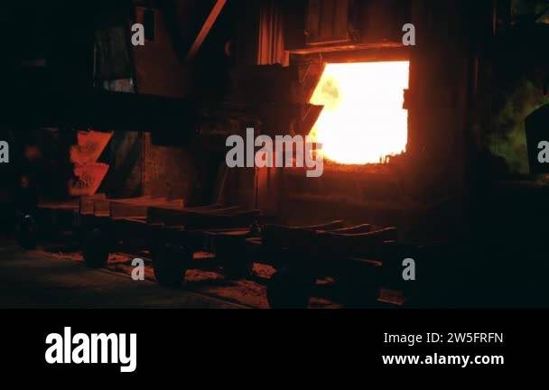 Automated mechanism is loading a reservoir into a furnace Stock Video ...