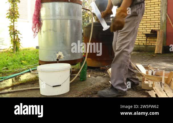 Taking liquor samples in laboratory graduated cylinder.Man takes a ...
