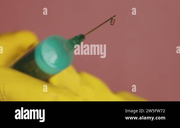 Syringe Needle with Liquid Dripping Drops of Medication in Doctor Hands ...