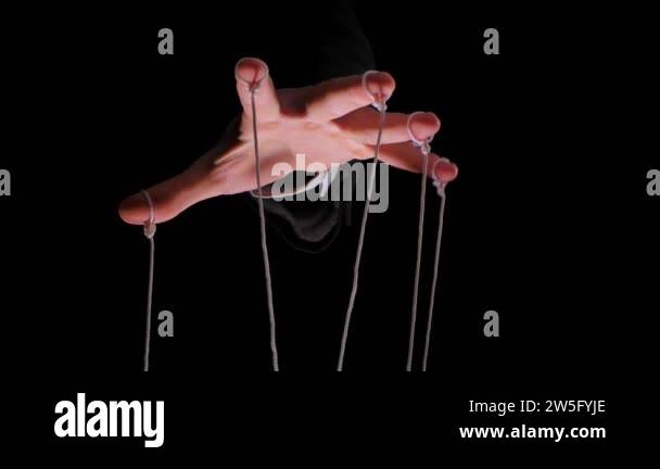 Hand of dictator in a business suit with strings on the fingers to ...