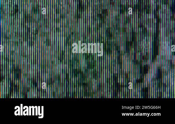 Pixels in the working old analog TV screen close up. Red, blue and ...