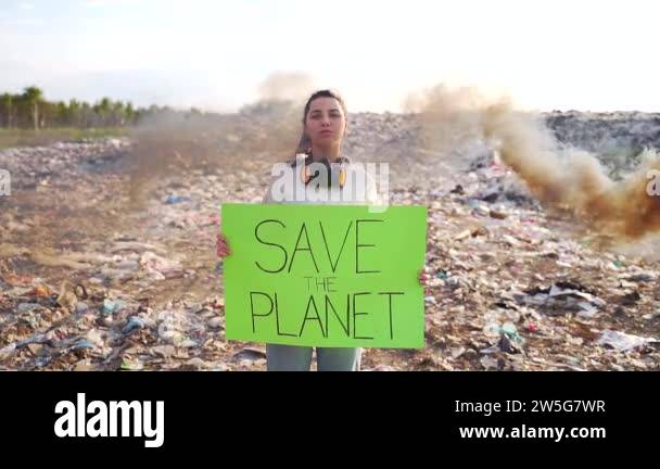 young woman activist with a poster in hands save the planet stands ...