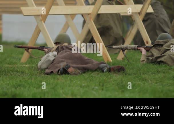 Red Army soviet soldiers with rifle gun aim at enemy, lie down on ...