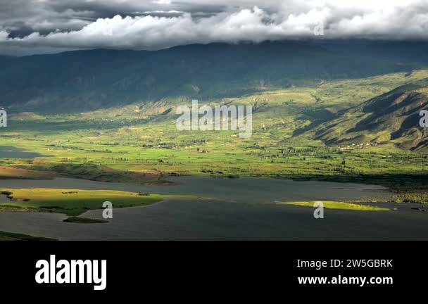 Trees and meadows in the hills around lake. Moorlands covered with ...