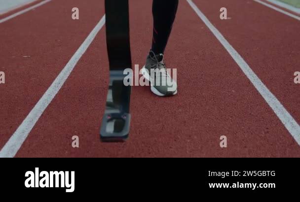Crop view of unknown disabled male person with prosthetic running ...