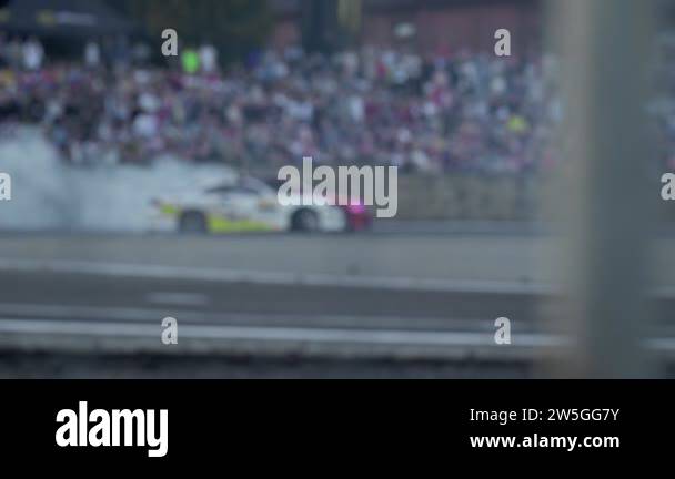 2 cars drift on sharp tight turn on asphalt road during show. Smoke ...