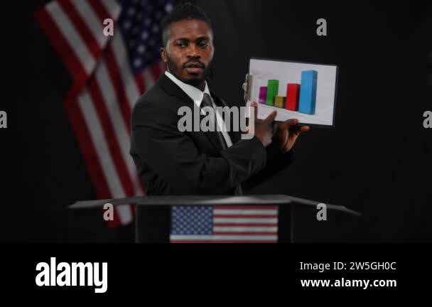 Handsome African American man pointing at graph talking with USA flag ...