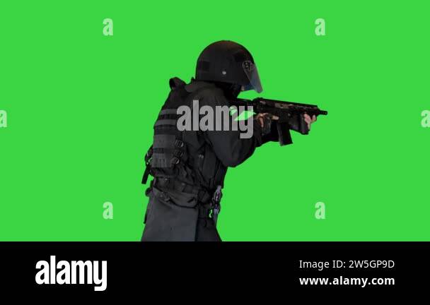 Armed SWAT Police Officer Aiming With a Rifle on a Green Screen, Chroma ...