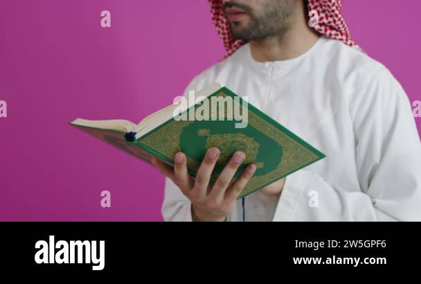 Young arabian muslim man in traditional clothes praying on the carpet ...