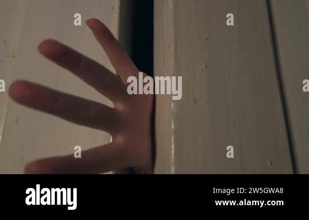 A close-up hand opening the door, from behind which a teenage girl ...